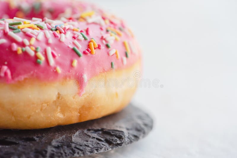 Donut with Pink Icing and Colored Sprinkles on the Small Black Slate ...