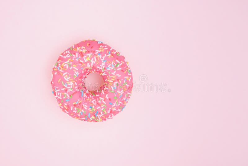 Donut with Pink Icing and Pastry Sprinkles on a Pink Background Stock ...