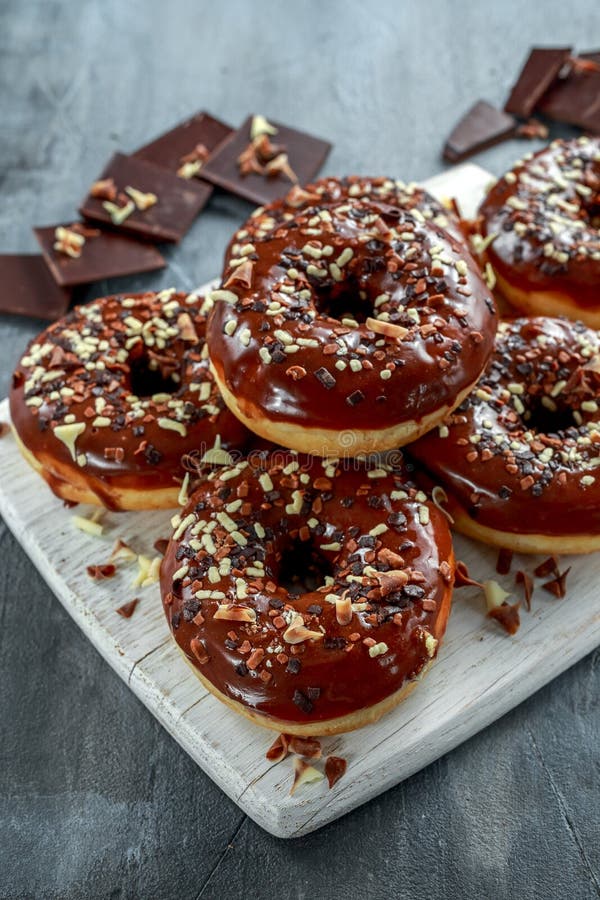 Donut Rings with White and Dark Chocolate Chippings and Icing Served on ...