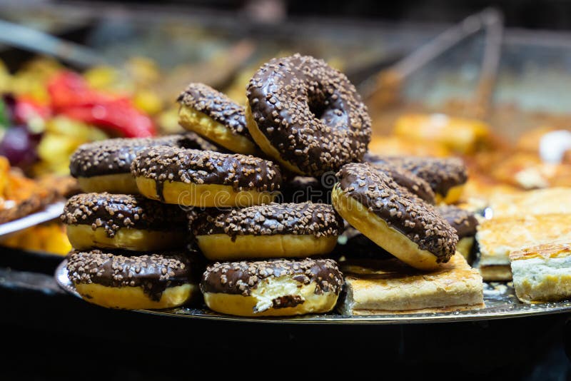 Donuts with Chocolate Icing and Nuts Stack Close-up Stock Image - Image ...