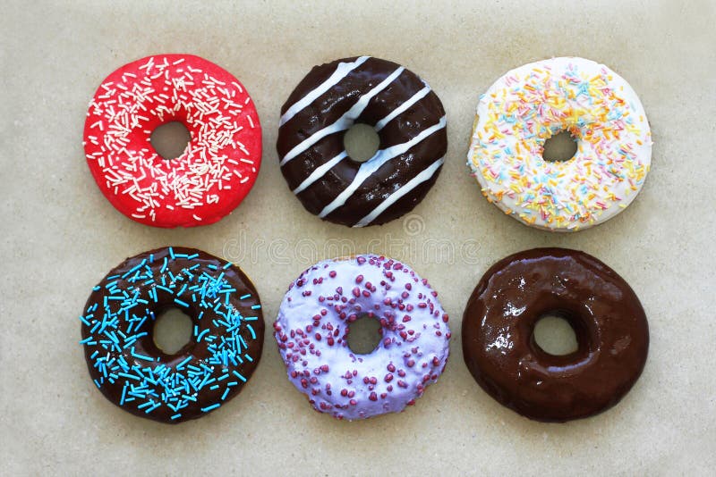 Donuts of Different Colors on Cardboard, Top View Stock Image - Image ...