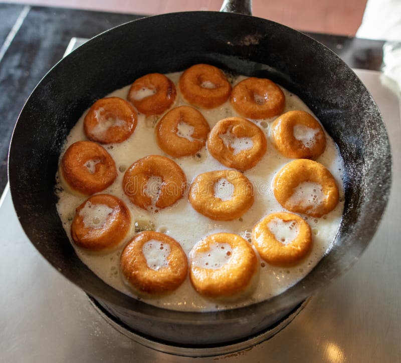 Donuts are Fried in a Frying Pan in Oil. Stock Image - Image of ...