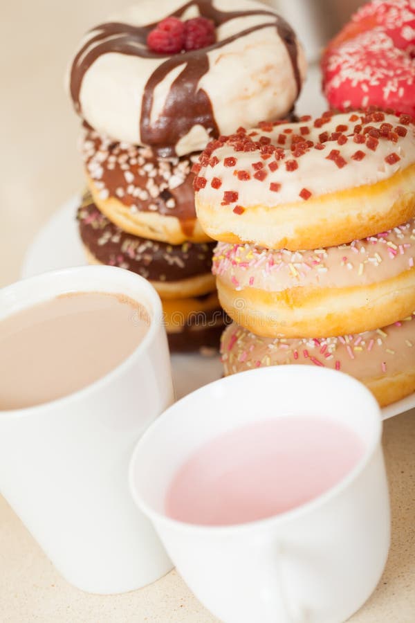 Donuts on plate with cups stock image. Image of bakery - 50840279