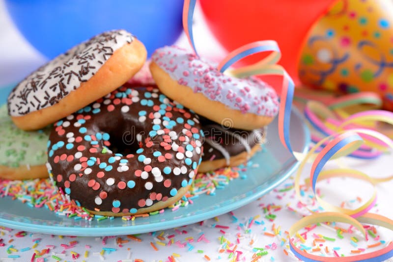 Donuts on a Plate with Party Decorations Stock Photo - Image of food ...