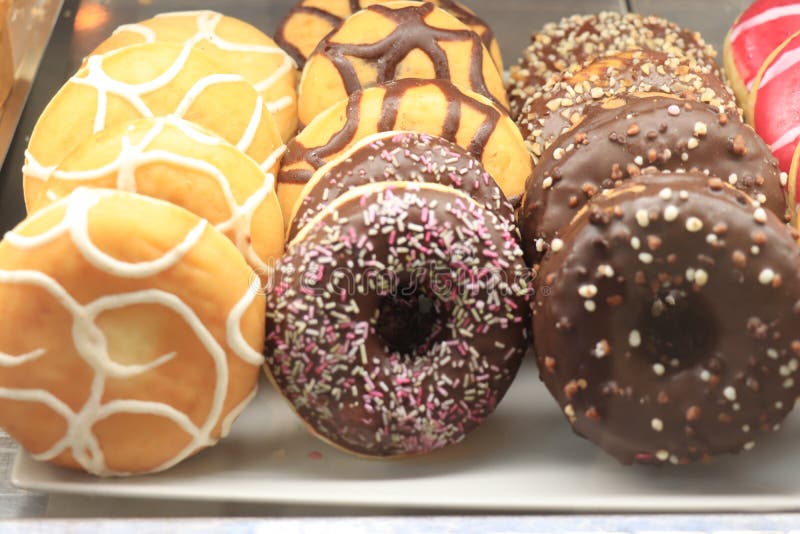 Donuts in shop window stock photo. Image of store, dessert - 167519132