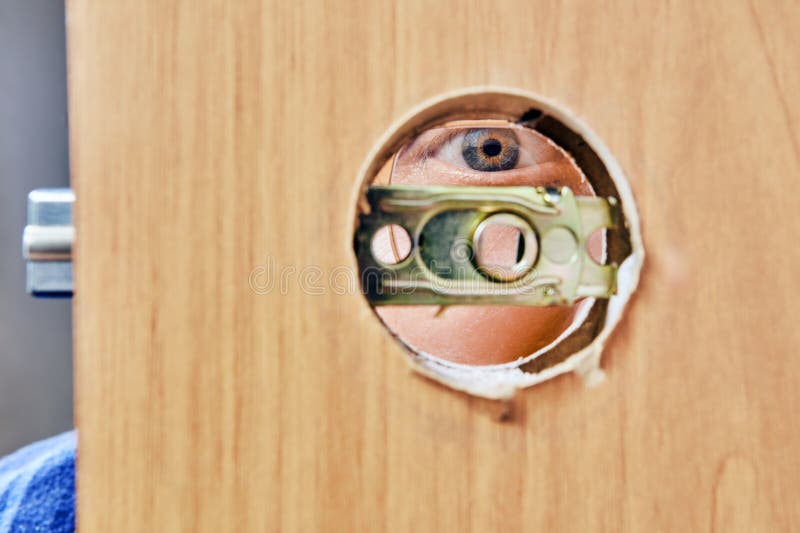 Latch Plate Aligns within Bore Hole of Wood Door, Exposing Human Eye ...