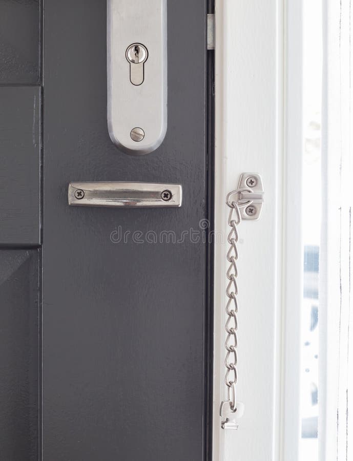 Door chain on a grey door stock image. Image of alarm - 90807919