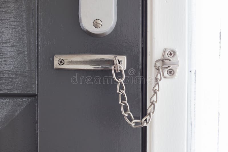 Door chain on a grey door stock photo. Image of burglary - 90808110