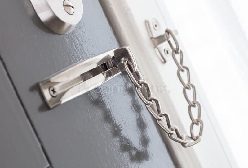 Door chain on a grey door stock photo. Image of metal - 91008684