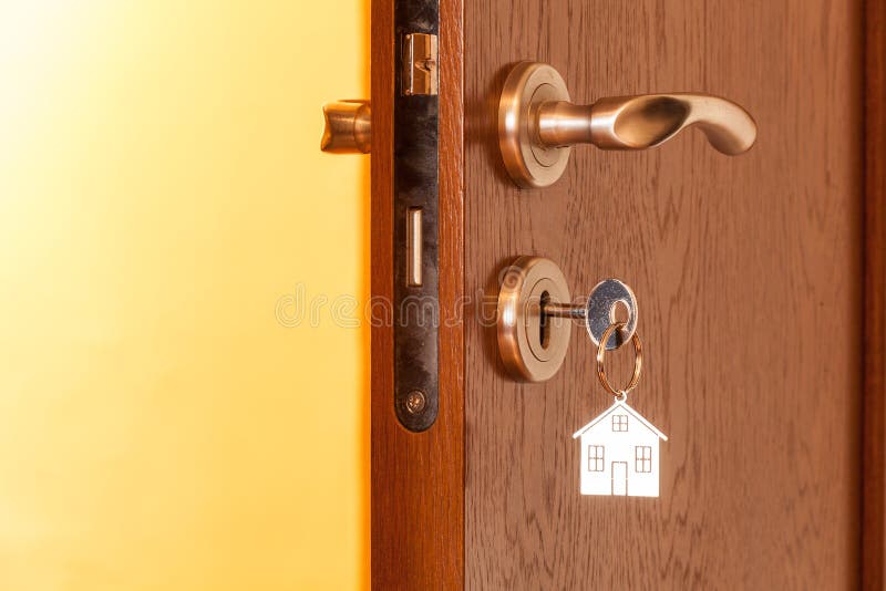 Door Handle with Inserted Key in the Keyhole and House Icon on it Stock ...