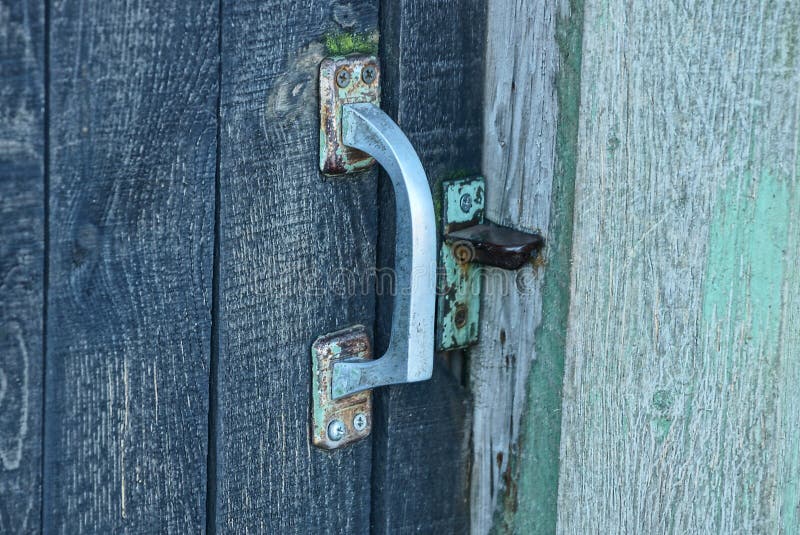 Door Handle with Lock on the Gray Wooden Door Stock Photo - Image of ...