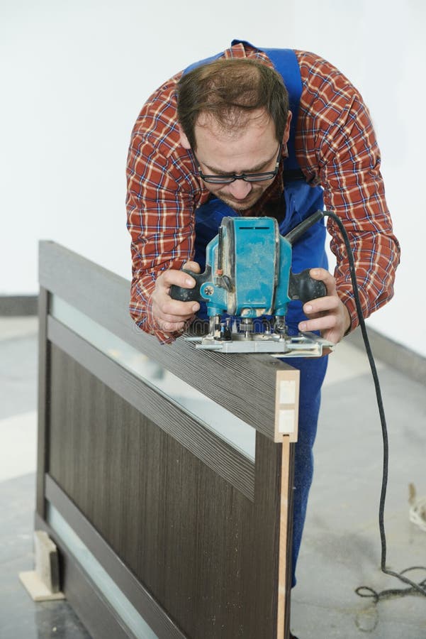 Door installer at work stock image. Image of builder - 47748325