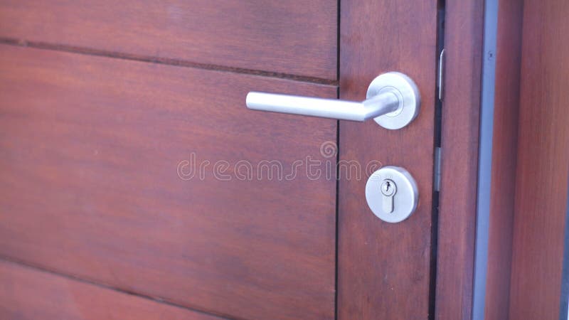 Door lock key with handle. stock photo. Image of plywood - 334267490