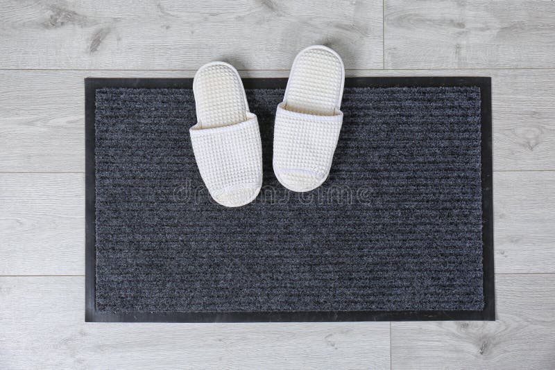 Door Mat and Slippers on Floor, Top View Stock Image - Image of carpet ...