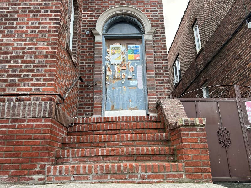 Door of a Red Brick Building with Multiple Caution Signs Stock Image ...