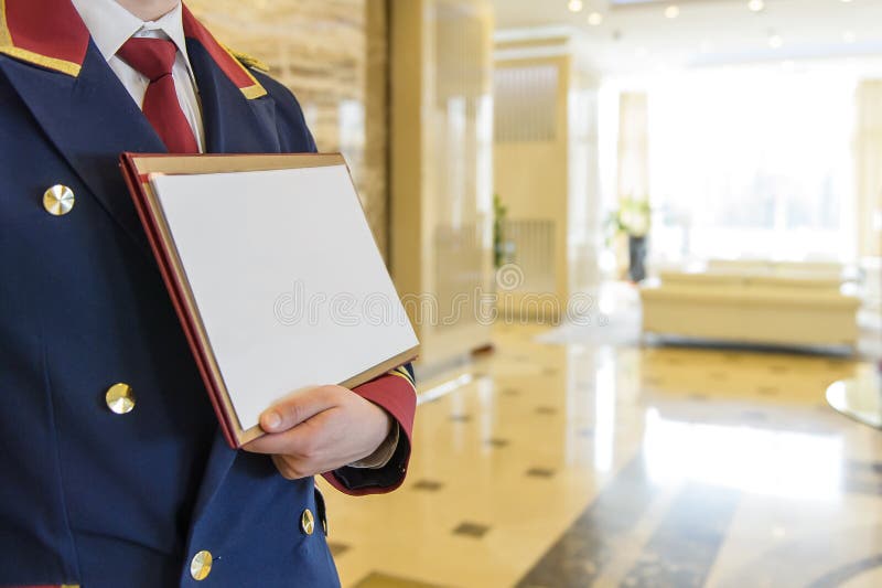 The Doorman in the Lobby of the Hotel Holding a Sign Stock Image ...