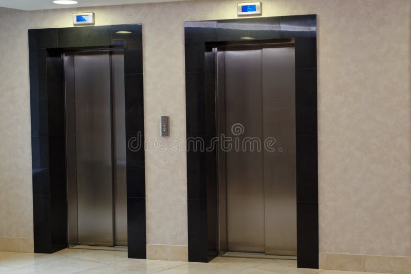 Doors of two elevators stock photo. Image of housing - 71434262