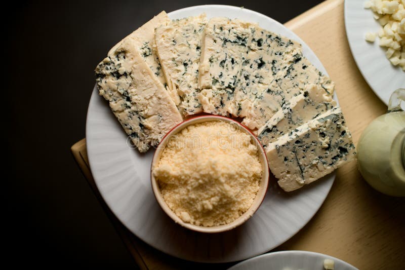 Dor Blu and Chopped Parmesan. Different Types of Cheese on White Plate ...