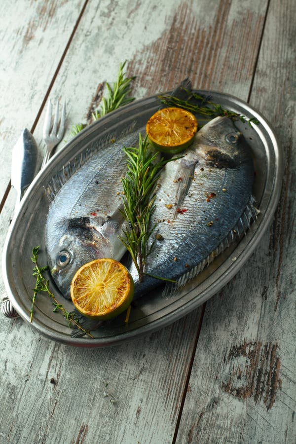 Dorada fish with lemon stock photo. Image of bream, eating - 59917470