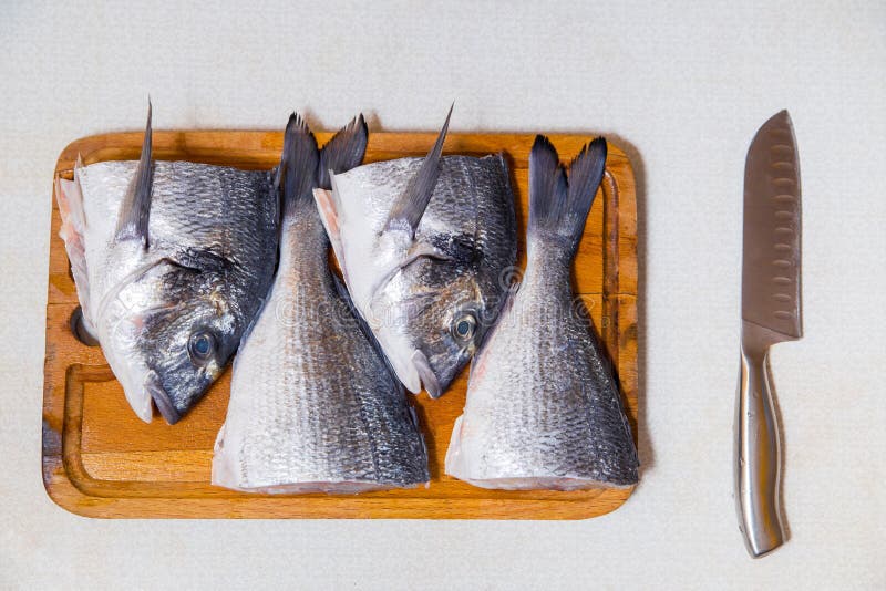 Dorado Fish on a Cutting Board Knife Cut Half Stock Image - Image of ...