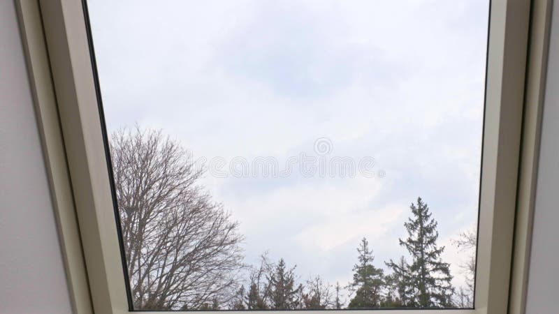 Dormer Window with Trees Visible Outside Under Cloudy Sky in Modern Home Interior. Stock Footage ...