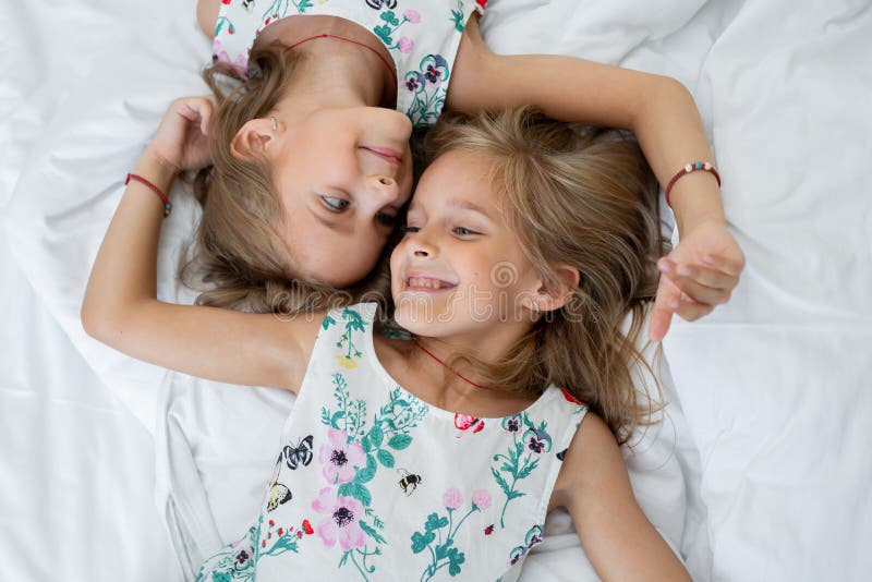 Dos Hermanas Gemelas Yacen En La Cama. Foto de archivo - Imagen de cama ...