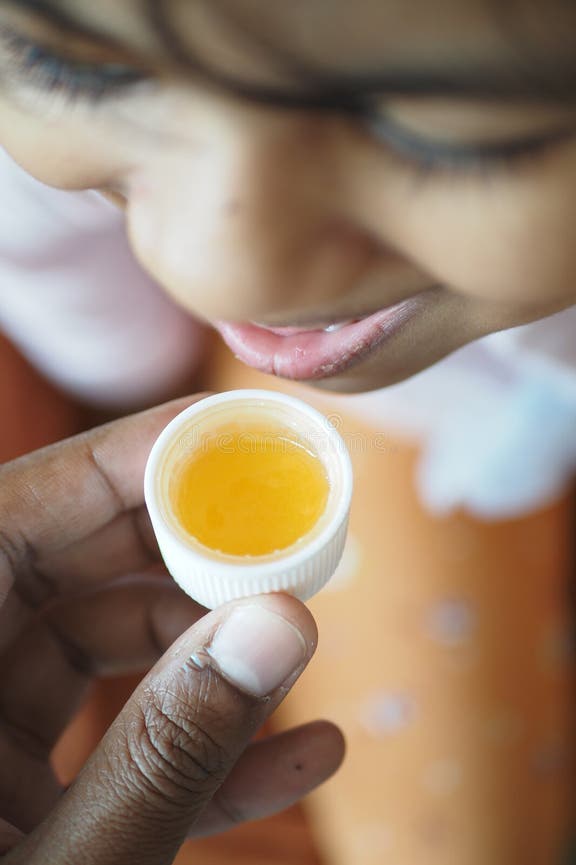 Child Taking a Dose of Cough Syrup. Stock Image - Image of plastic ...