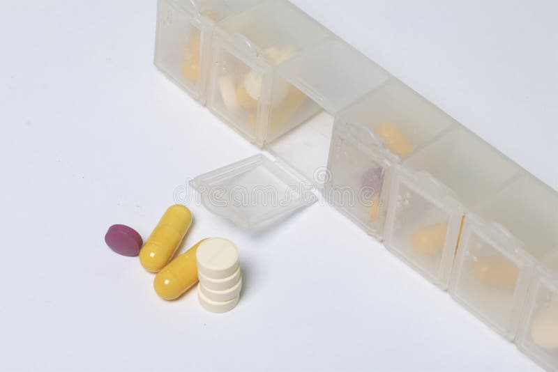 A daily Dose of Tablets Lies Near a Special Container for daily ...