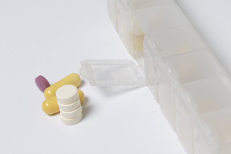 A daily Dose of Tablets Lies Near a Special Container for daily ...