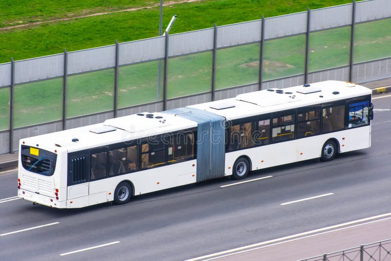 Double Articulated Bus Rides on the Highway in the City Stock Photo ...