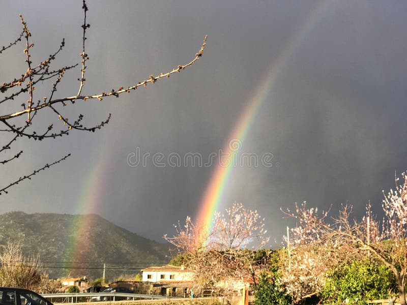 Double Beautiful Rainbow on Countryside on Blooming at Springtim Stock ...