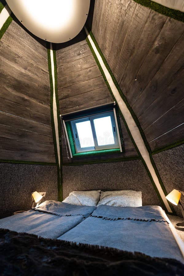 Double Bed in Bedroom of Pyramid Shape Wooden Cabin. Pyramid Shape ...
