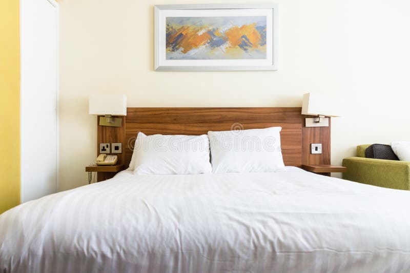 Hotel Room with Simple Bed and Wall Paint Art Editorial Image - Image ...