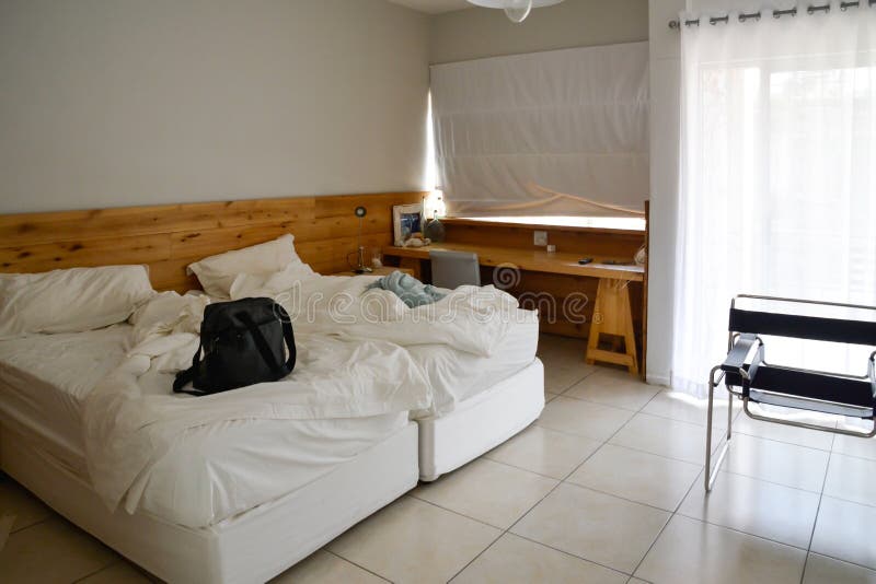 A Double Bed Spread Out with White Blankets in a Hotel Room or ...