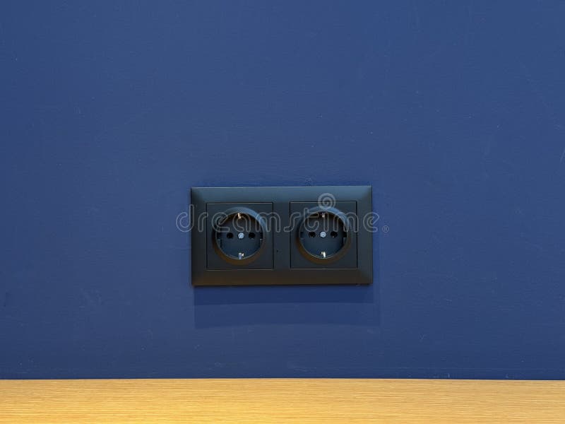 Double Black Designer Socket in Blue Wall Stock Photo - Image of ...
