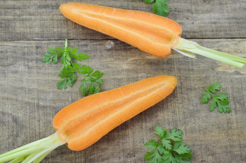 Double Cut Carrot on Wooden Background Stock Photo - Image of ...