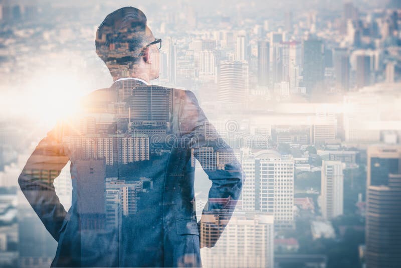 The Double Exposure Image Of The Businessman Standing Back During Sunrise Overlay With Cityscape