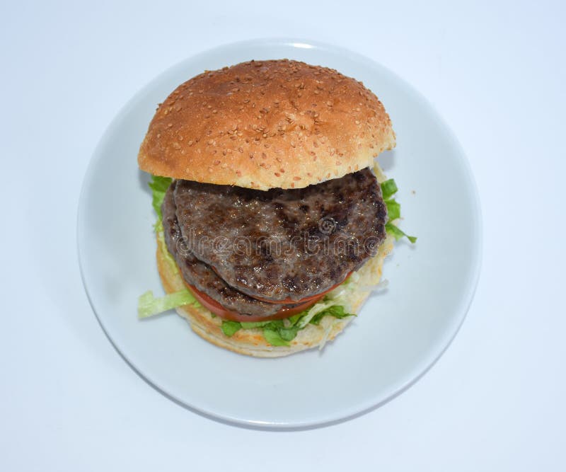 Top View of Double Hamburger with Lettuce and Tomato on Plate Stock ...