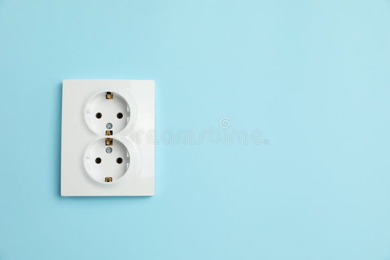 Double Power Socket on Light Blue Wall, Space for Text. Electrical ...