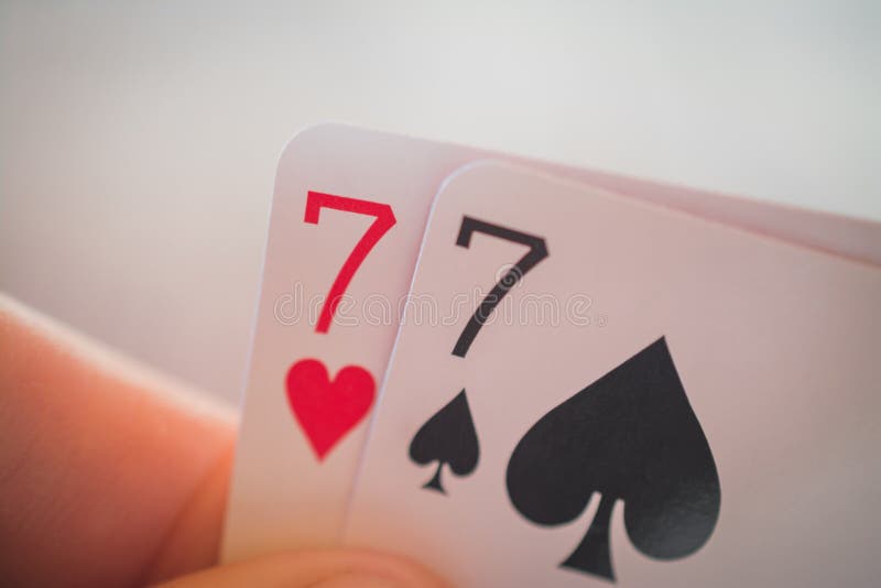 Double Seven, Playing Cards in Hand on the Table, Poker Nands Stock ...