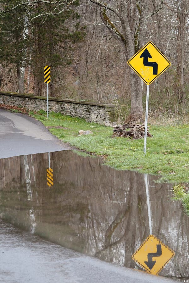 A Double Sign for a Crooked Road because of the Reflection. Stock Image ...