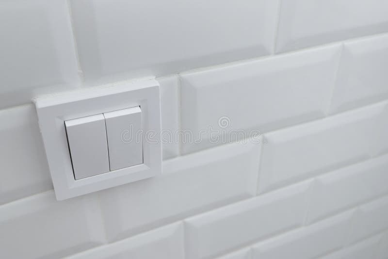 Double Switch Installed in Glossy Tiled Wall Stock Photo - Image of ...