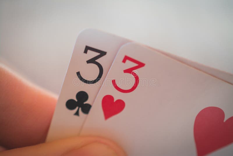 Double Three, Playing Cards in Hand on the Table, Poker Nands Stock ...