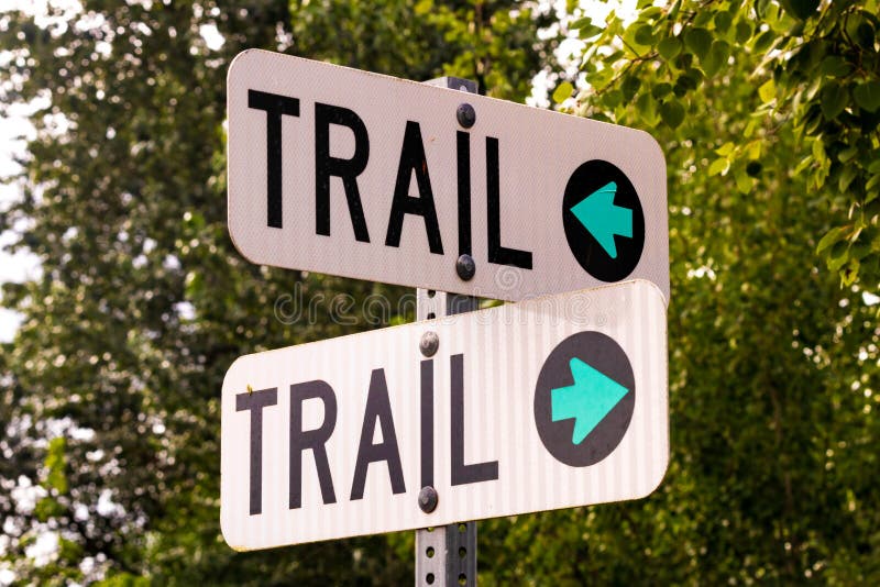 Double Trail Sign on a Post with Blue Arrows Stock Image - Image of ...