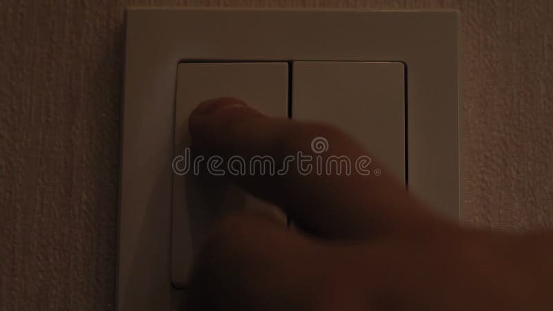 Mans Hand Turning Light Switch in Double Switch. Turning on the Light ...