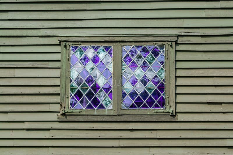 Double Window with Purple Panes in a Diamond Pattern in the Wall of a ...