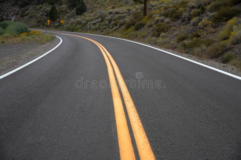 Double Yellow Lines on Paved Mountain Road, Downhill Curve Ahead Stock ...