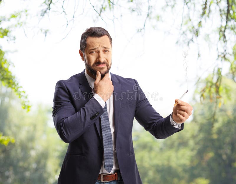 Doubtful Young European Blond Guy in a Striped Polo Shirt with a Tattoo ...