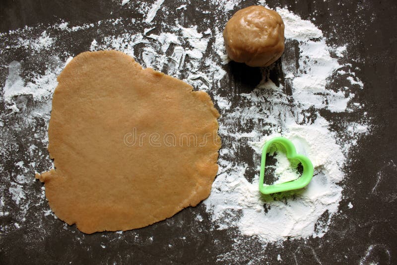 Dough and Cookie Mold in the Shape of Heart on Black Background. Ginger ...