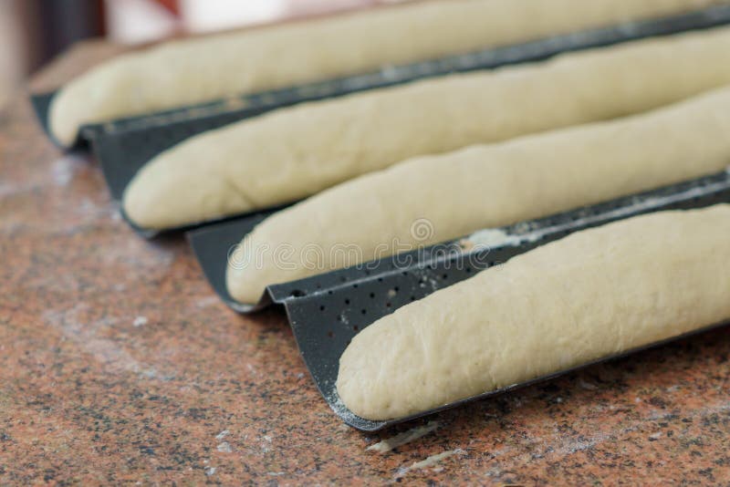 Dough in the Kitchen. French Baguettes on a Baking Sheet. Homemade ...